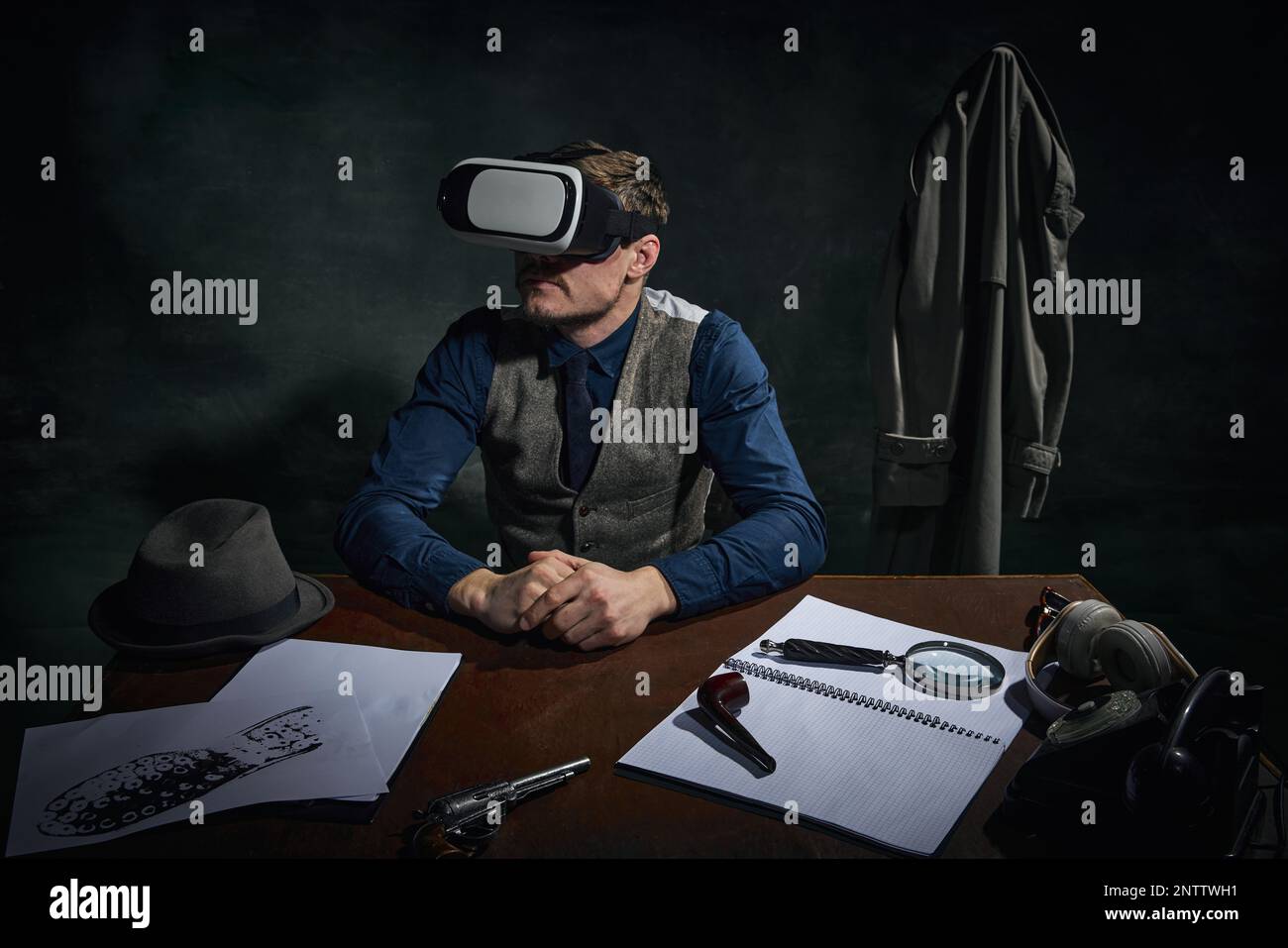 Professional detective in classical clothes sitting at table in VR ...