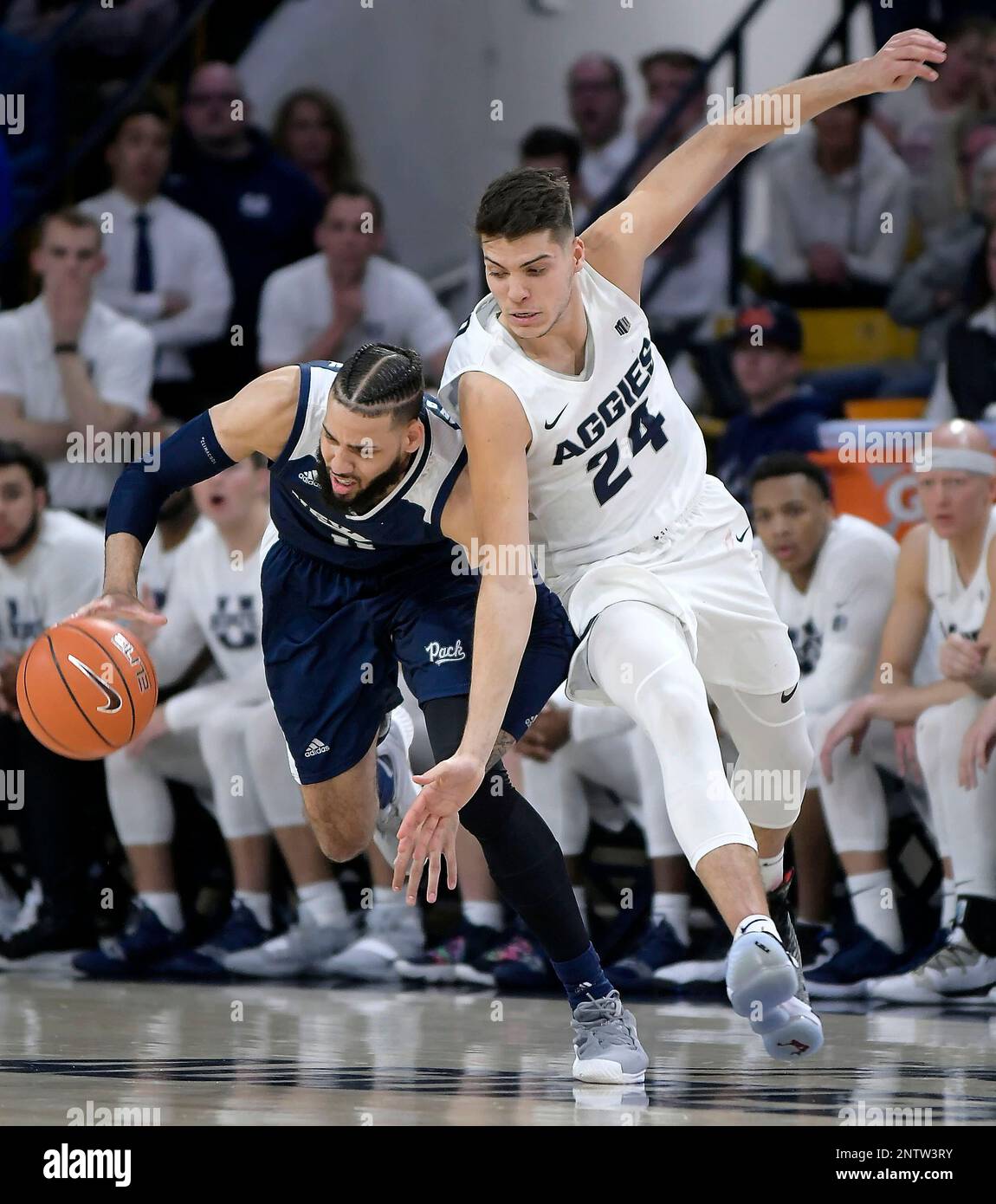Nevada forward Cody Martin (11) gets fouled by Utah State guard Diogo ...