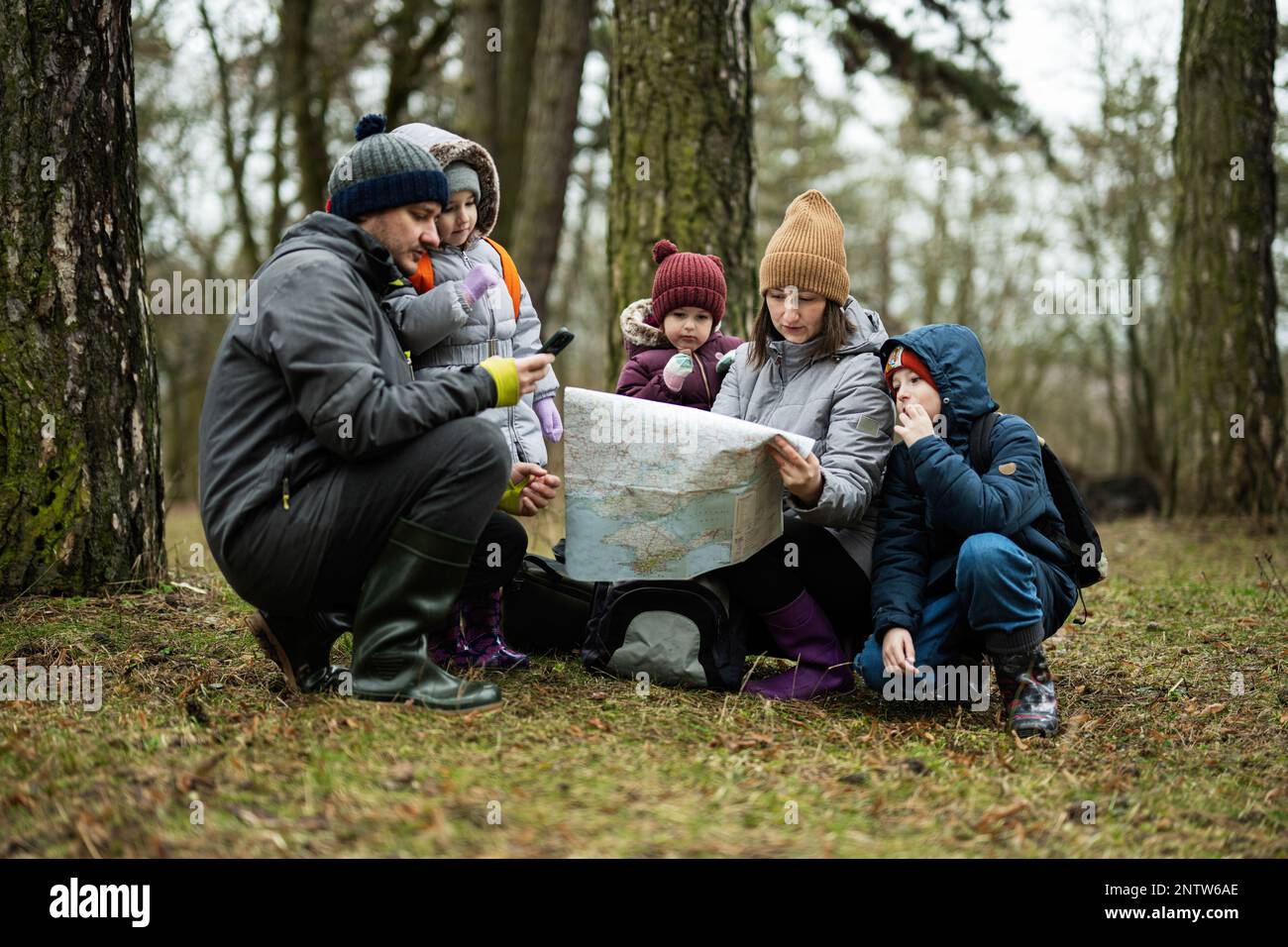Family and kids with map in the forest Stock Photo - Alamy