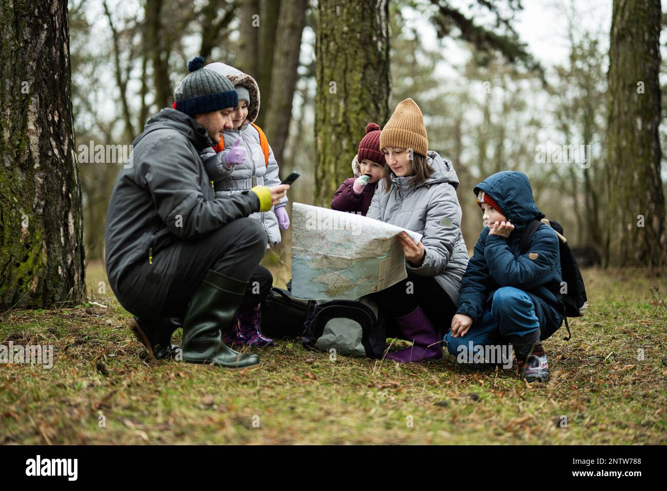 Family and kids with map in the forest Stock Photo - Alamy