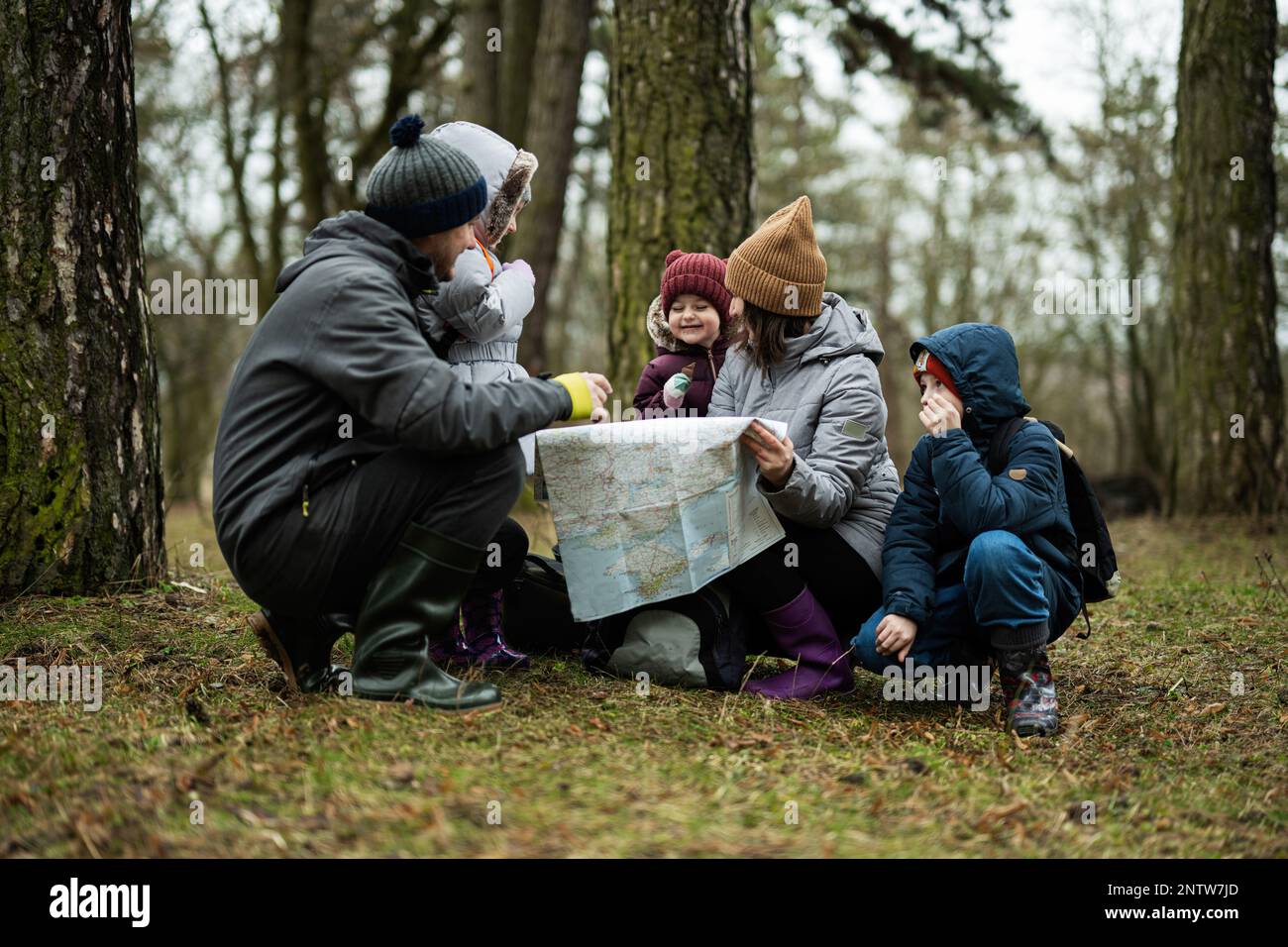 Family and kids with map in the forest Stock Photo - Alamy