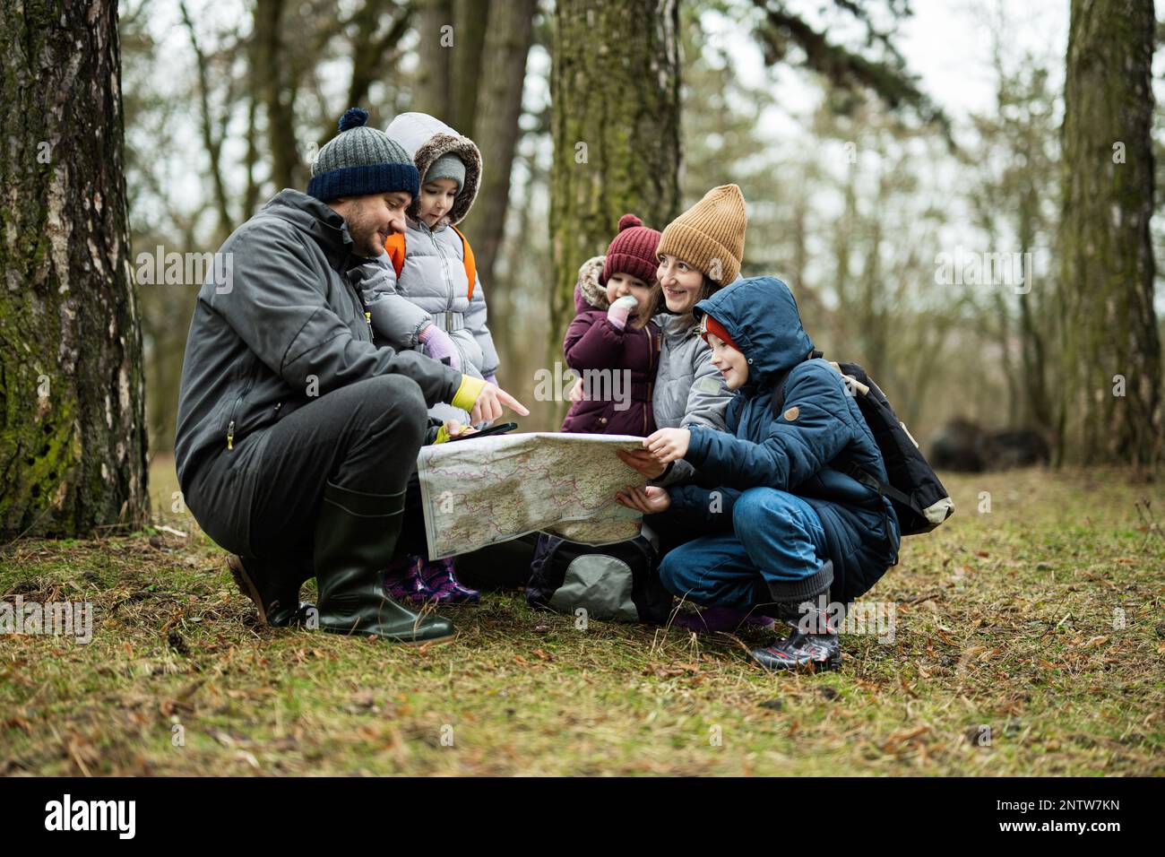 Family and kids with map in the forest Stock Photo - Alamy
