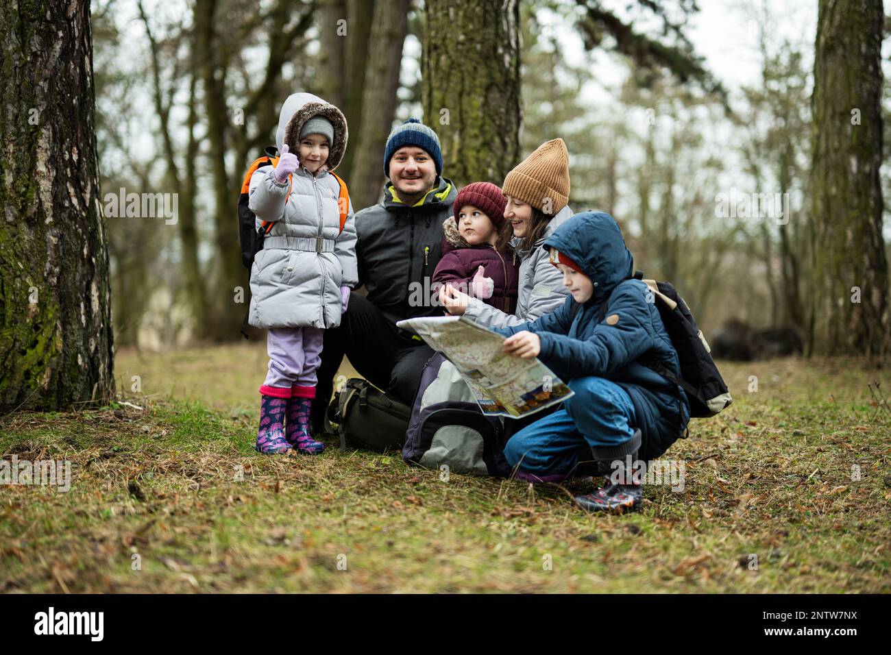 Family and kids with map in the forest Stock Photo - Alamy