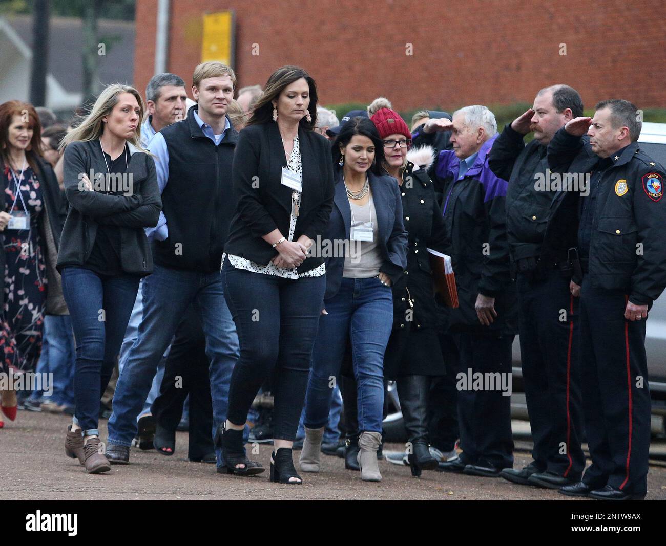 Members of the Vicha family are greeted with a salute from current and ...