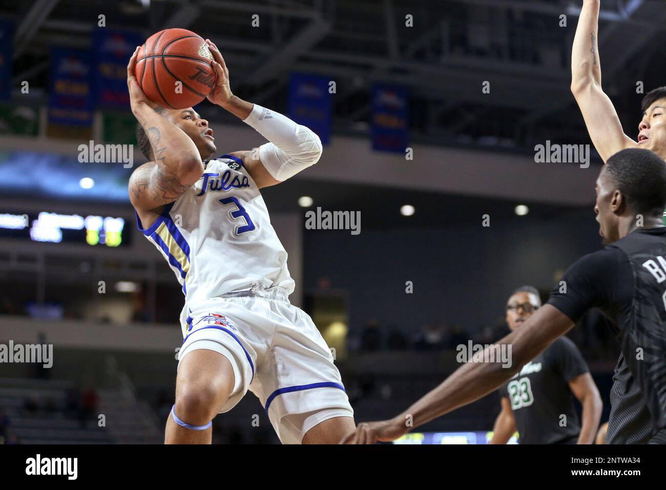 Tulsa guard Elijah Joiner (3) shoots over Tulane players during an NCAA ...