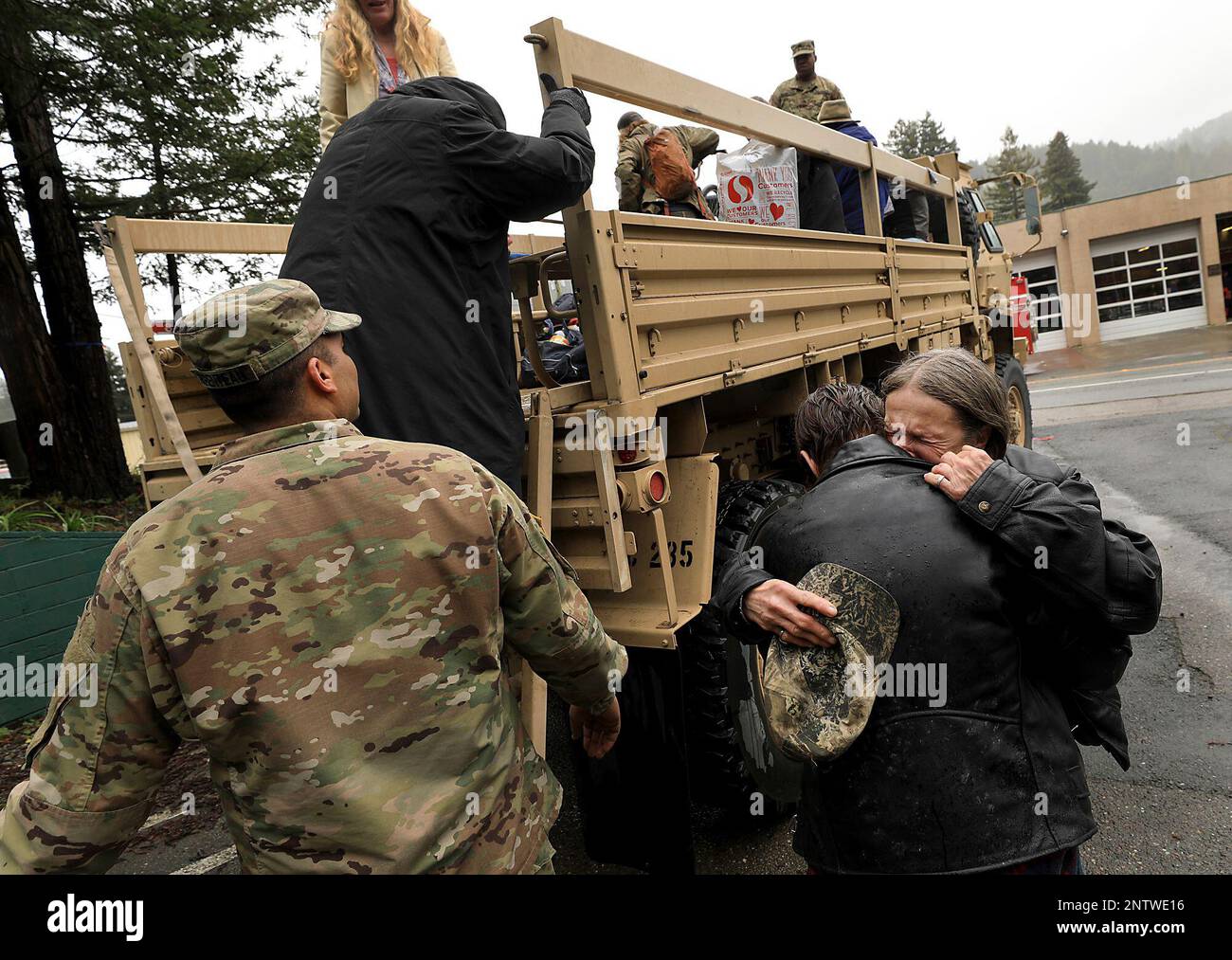 Chris Tipton and a friend embrace as they finally get to leave on a ...