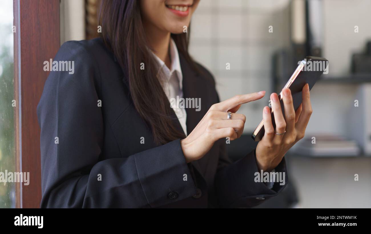 Secretary concept, Female secretary working on smartphone and standing ...
