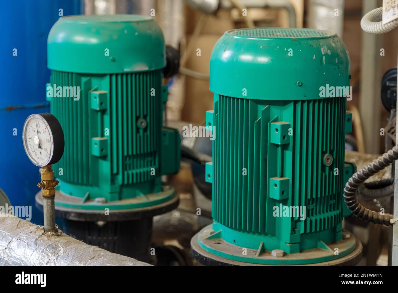 Electric pump with manometer. Pump station in the basement Stock Photo ...