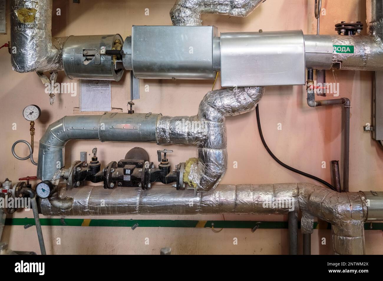 Industrial switching of heating pipes in the basement Stock Photo - Alamy