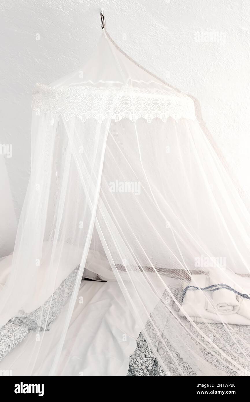 Ceiling hung mosquito netting in Santorini scafta room in Greece Stock ...