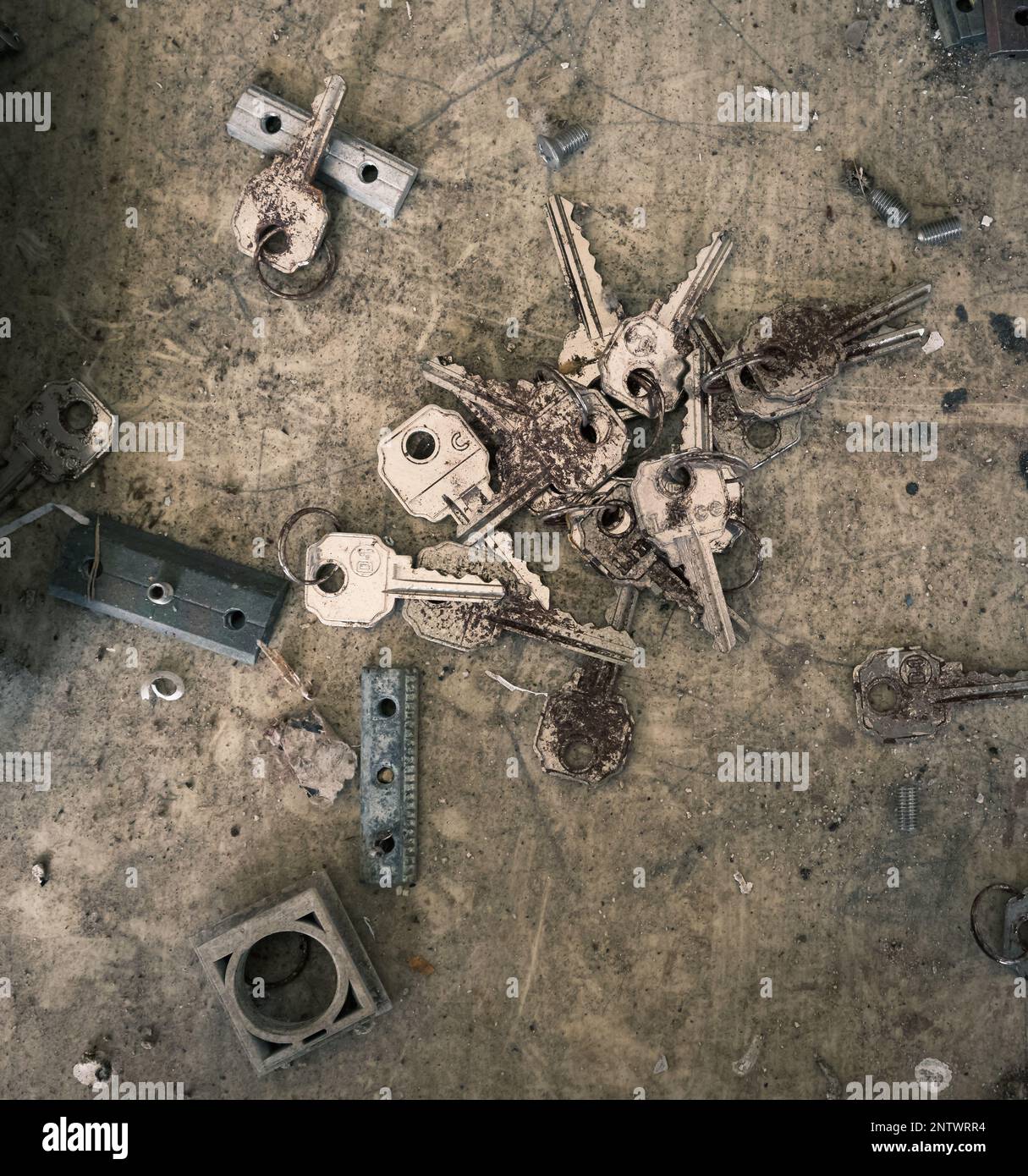 Locksmith background with old keys and lock parts in an abandoned ...
