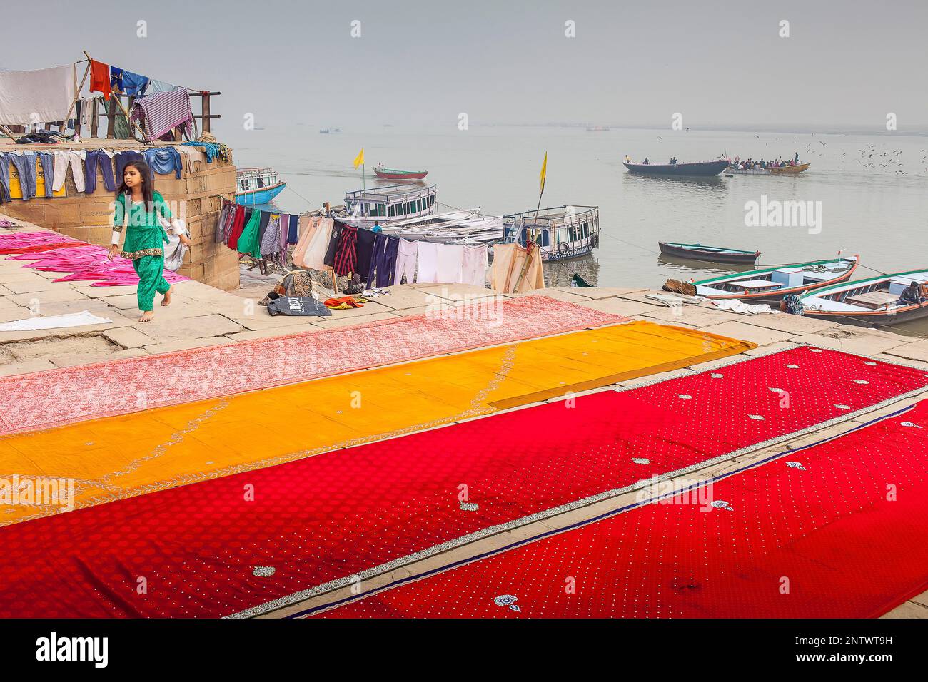 incidentally girl and laundry drying, Dasaswamedh Ghat, in Ganges river ...