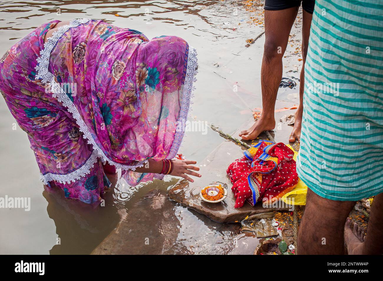 Woman making offering, in the ghats of Ganges river, Varanasi, Uttar ...