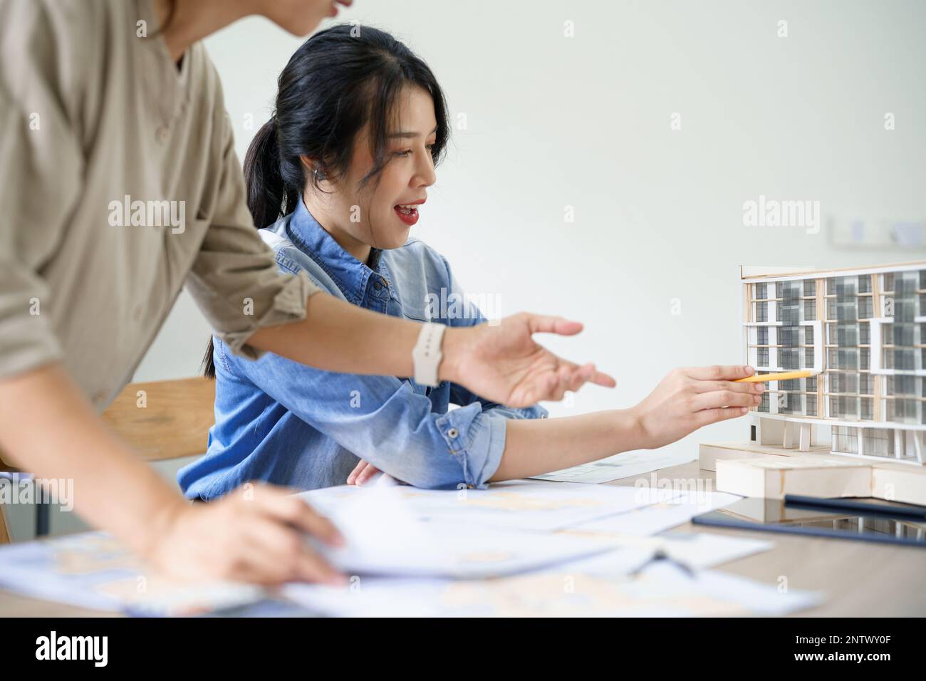 Concept of engineering consulting, Two female engineers pointing and ...