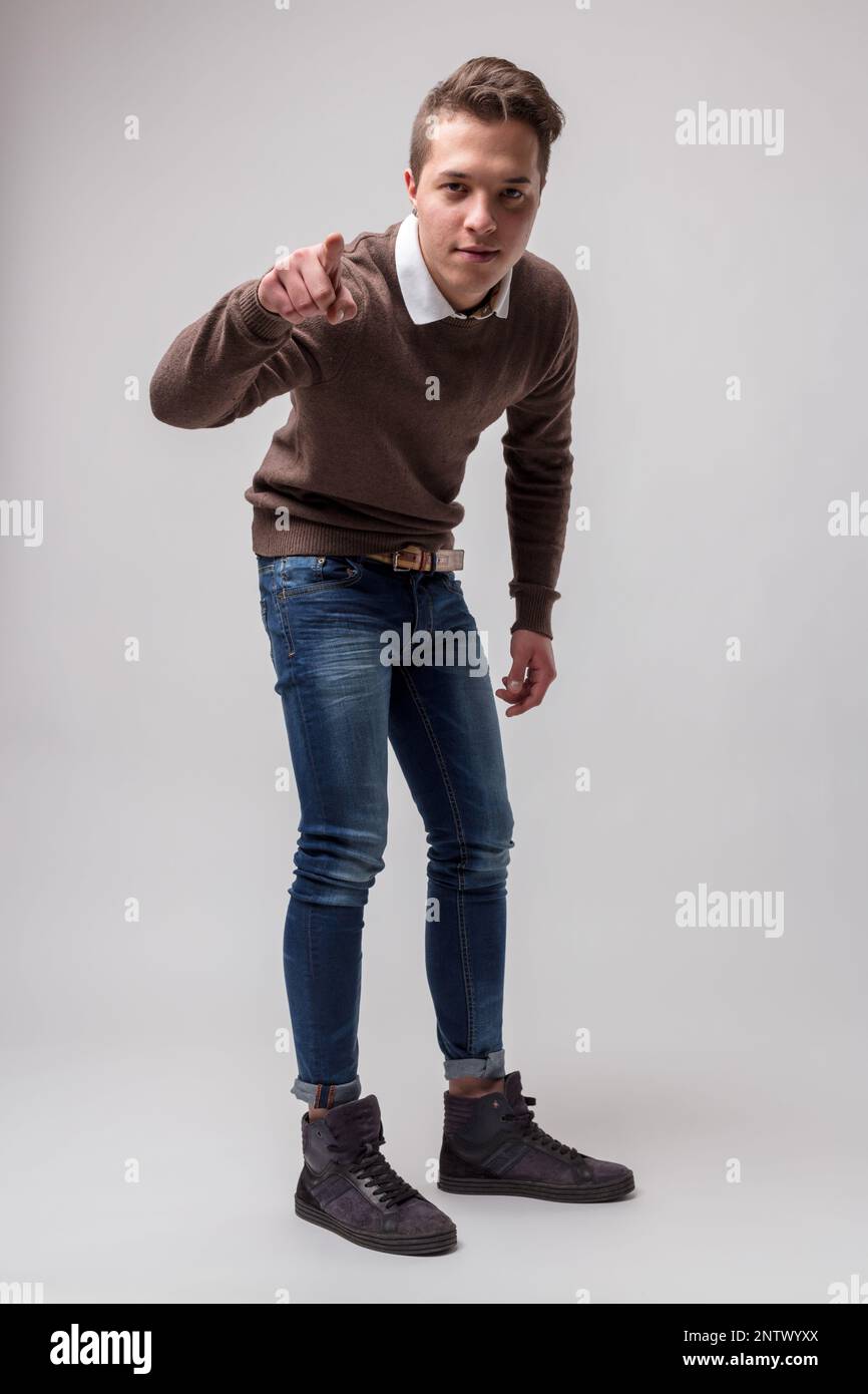 Portrait of young man with short hair and topknot fashionable in the ...