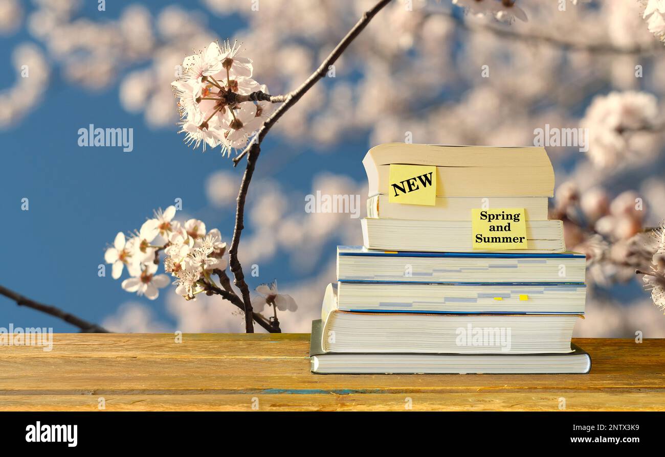 New book releases for spring 2023, with stack of books and cherry ...