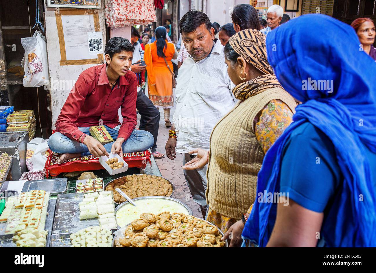 Man selling sweets. Candy store or confectionery, in Gotam Nagar street ...