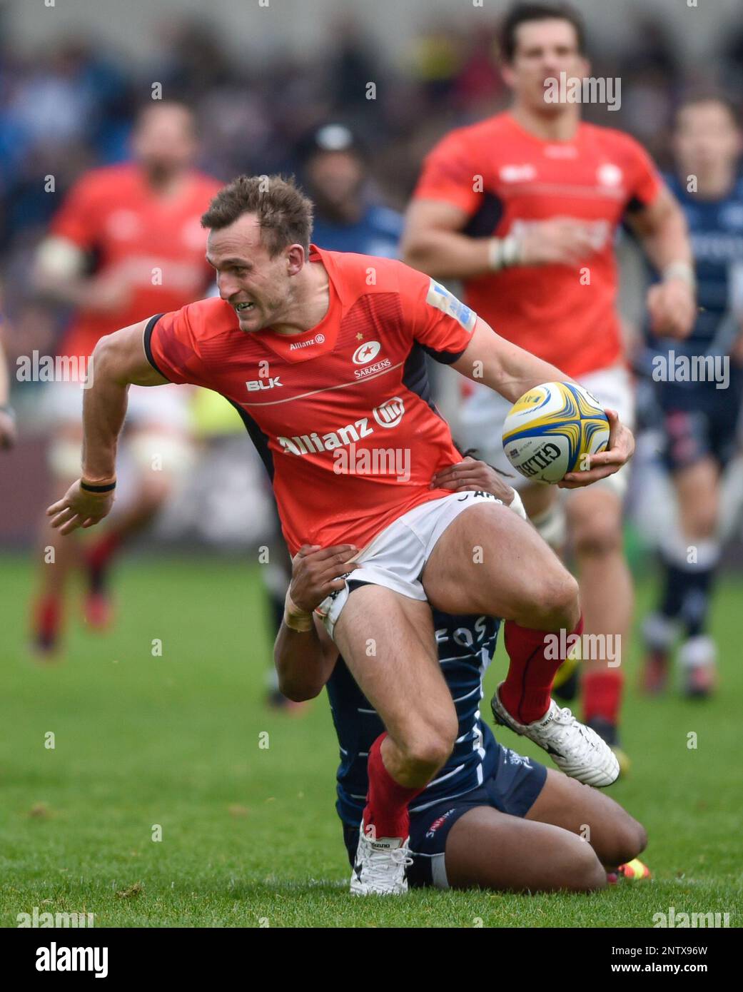 Saracens full-back Andrew Fenby is held by Sale Sharks wing Paolo ...