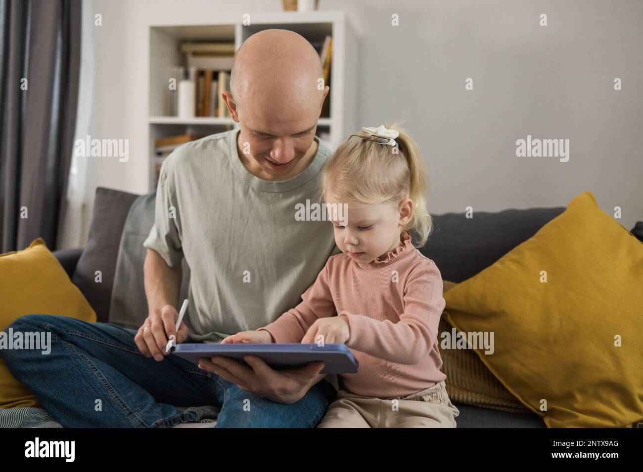People with cochlear implant system. Kid study to hear with her father ...