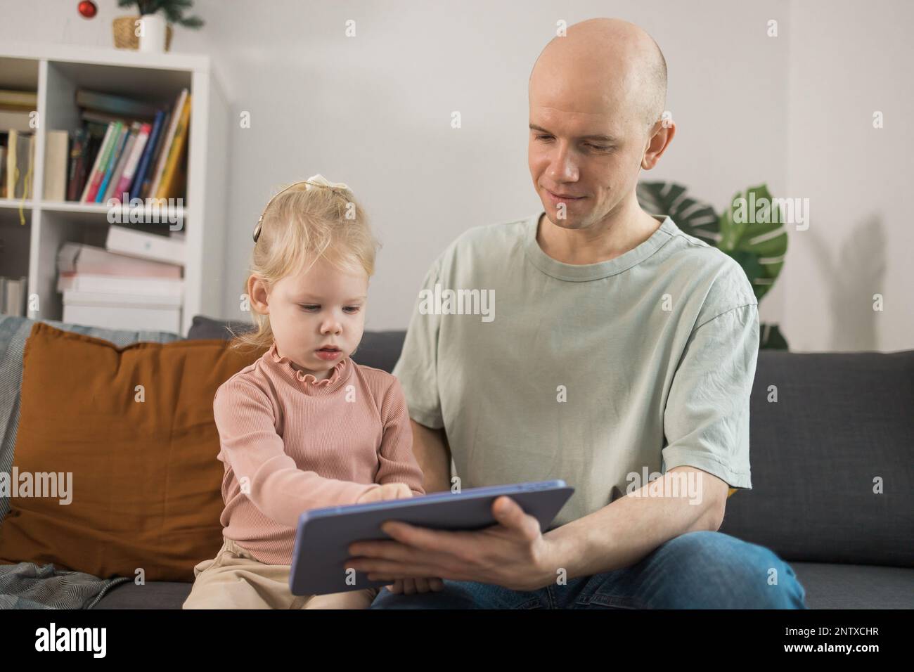 People with cochlear implant system. Kid study to hear with her father ...