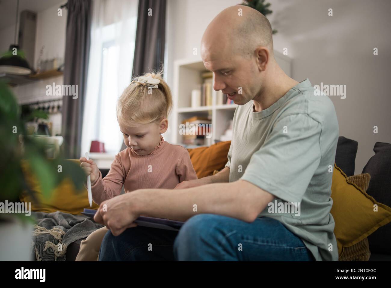 People with cochlear implant system. Kid study to hear with her father ...