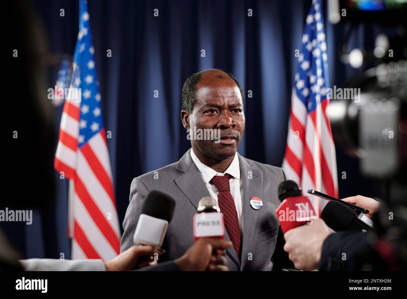 Serious mature male politician in formalwear giving interview to ...
