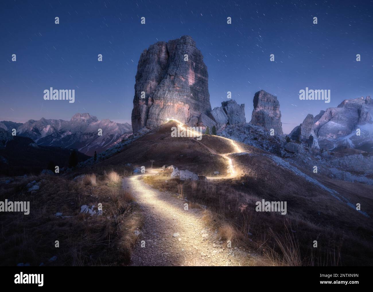 Flashlight trails on mountain path against high rocks at night Stock ...