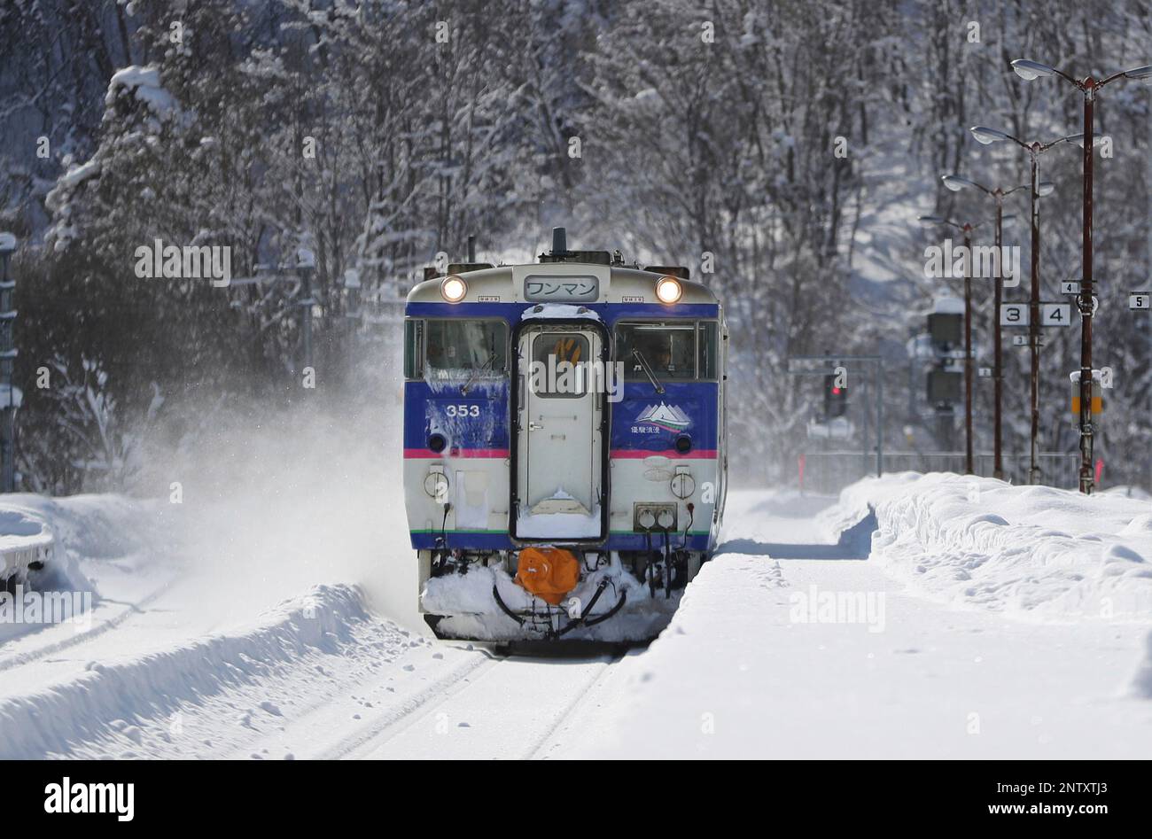 A train runs through snow covered landscape of Yubari City, Hokkaido on ...