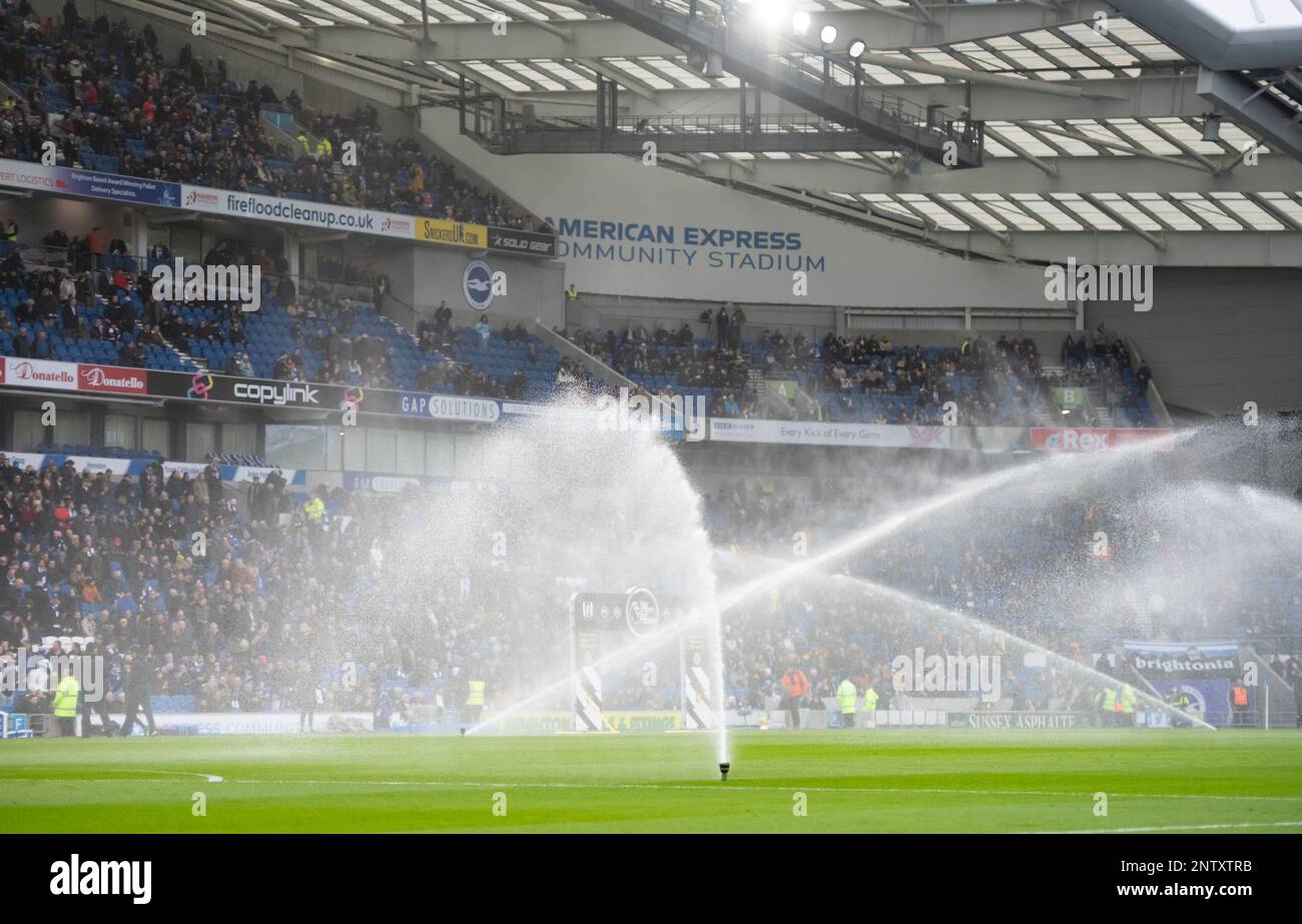 Sprinklers water the pitch before the Premier League match Brighton and ...