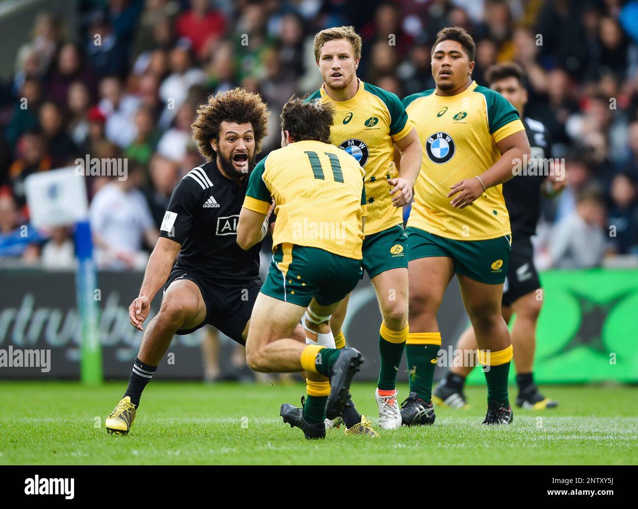 Australia wing Liam McNamara runs at New Zealand wing Caleb Makene ...