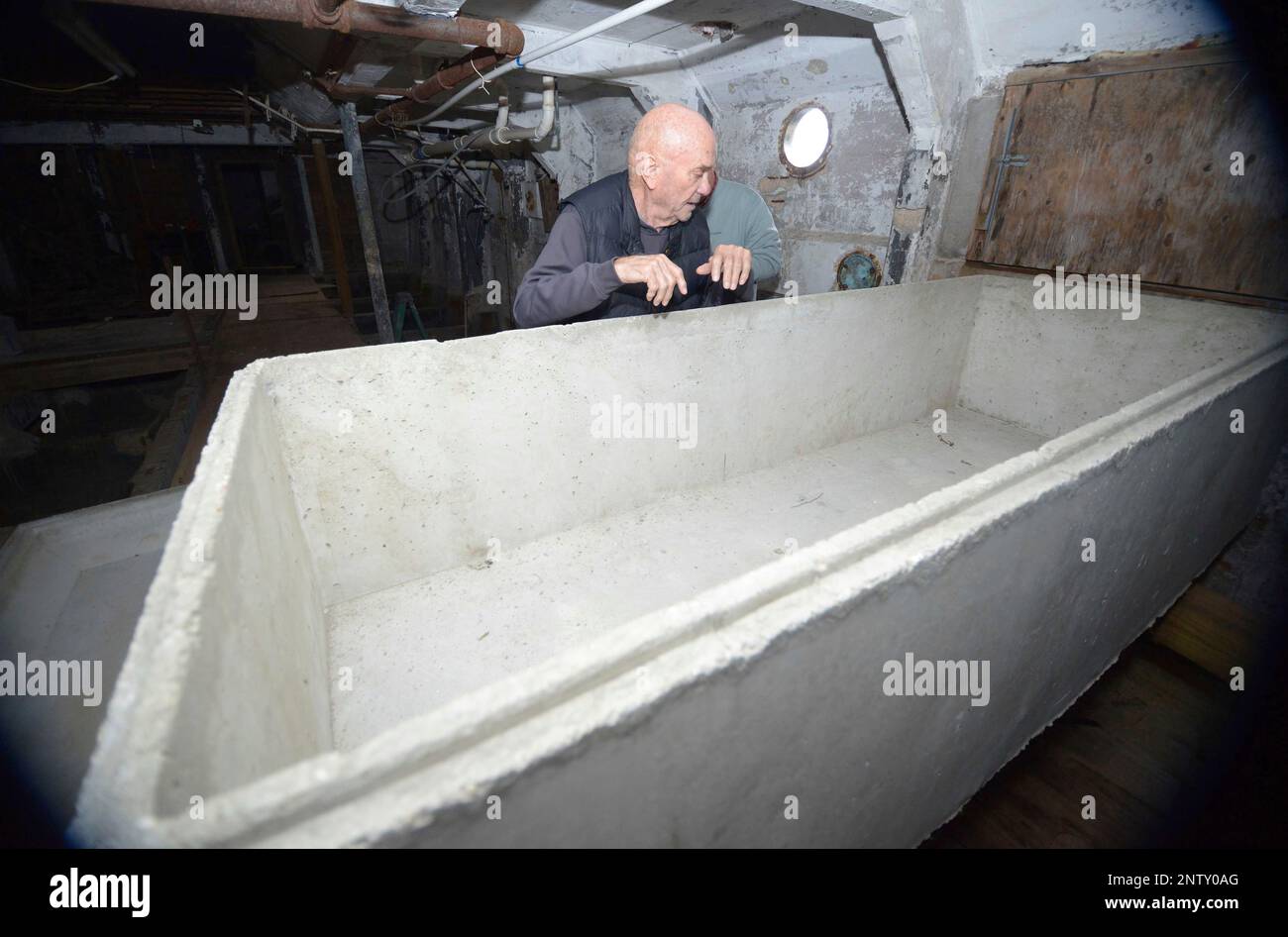 Jim Tucker looks in the vault of his boat in Fort Walton Beach, Fla ...