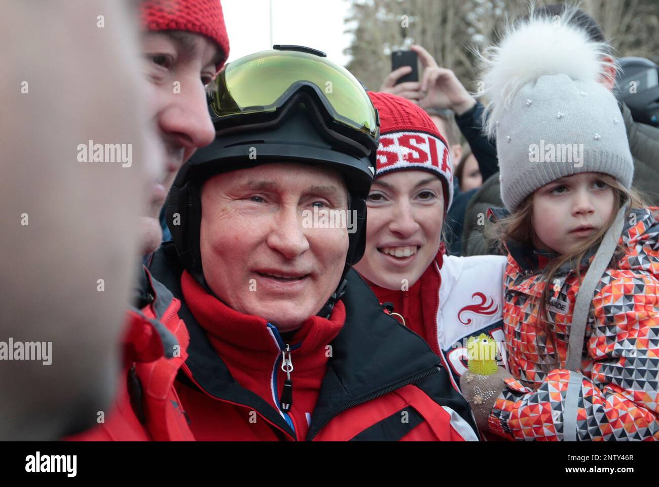 Russian President Vladimir Putin poses for a photo people after skiing ...