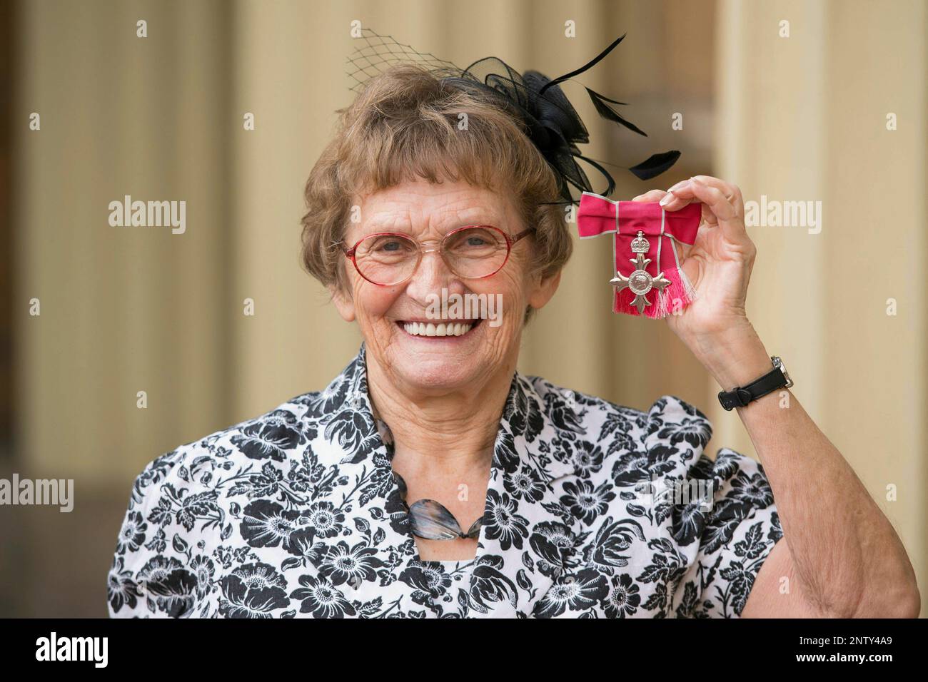 Former England cricketer Enid Bakewell poses with her MBE medal, after ...