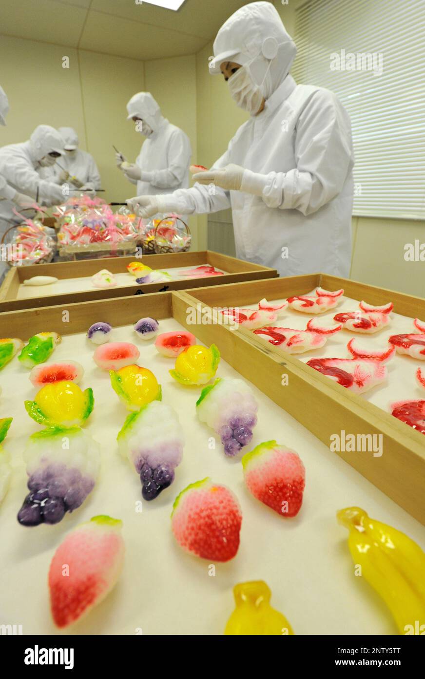 Workers are producing Kinkato, local sweet candy, shaped like sea bream ...