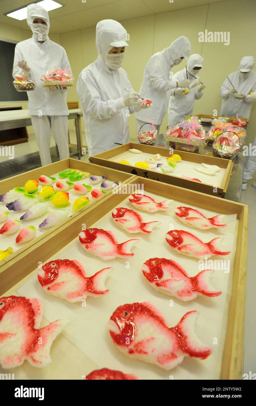 Workers are producing Kinkato, local sweet candy, shaped like sea bream ...