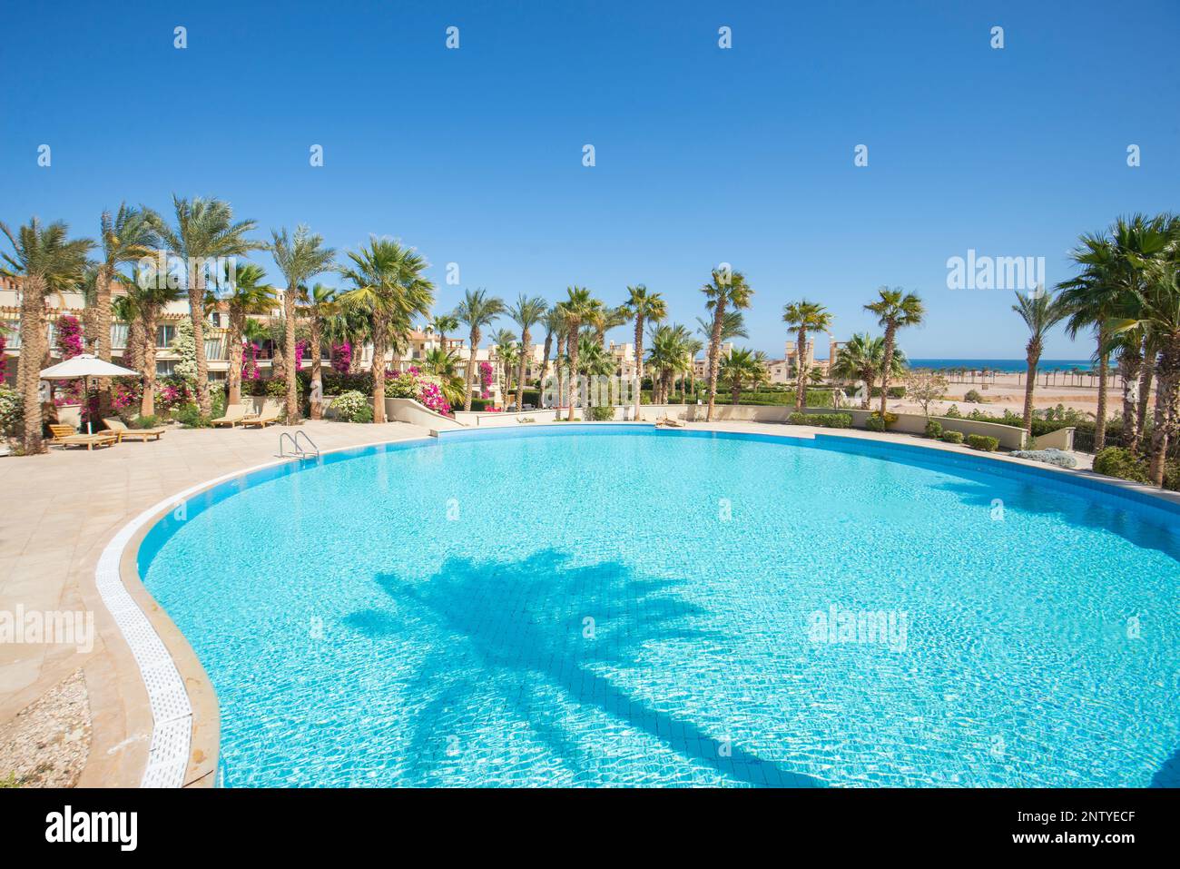 Large outdoor swimming pool at a luxury tropical hotel apartment resort ...