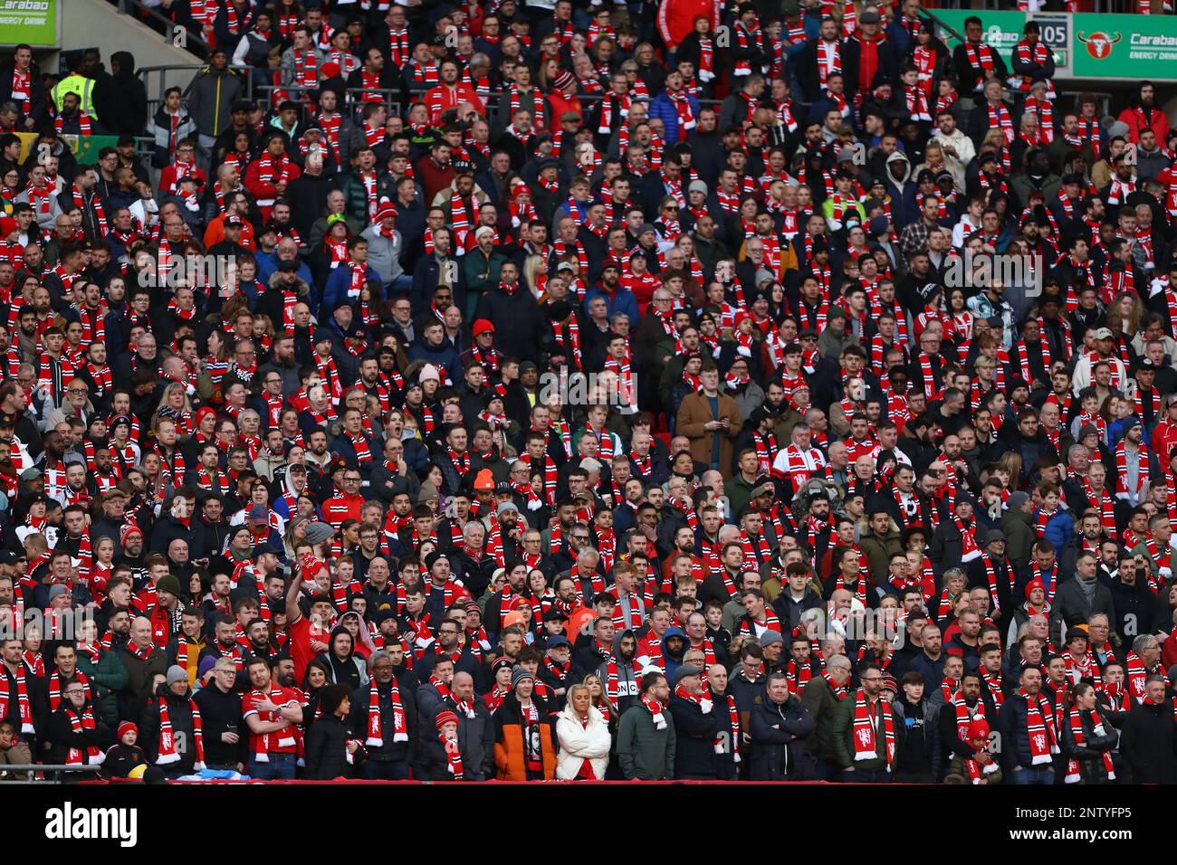 Manchester United fans are seen wearing res, white and black scarfs ...