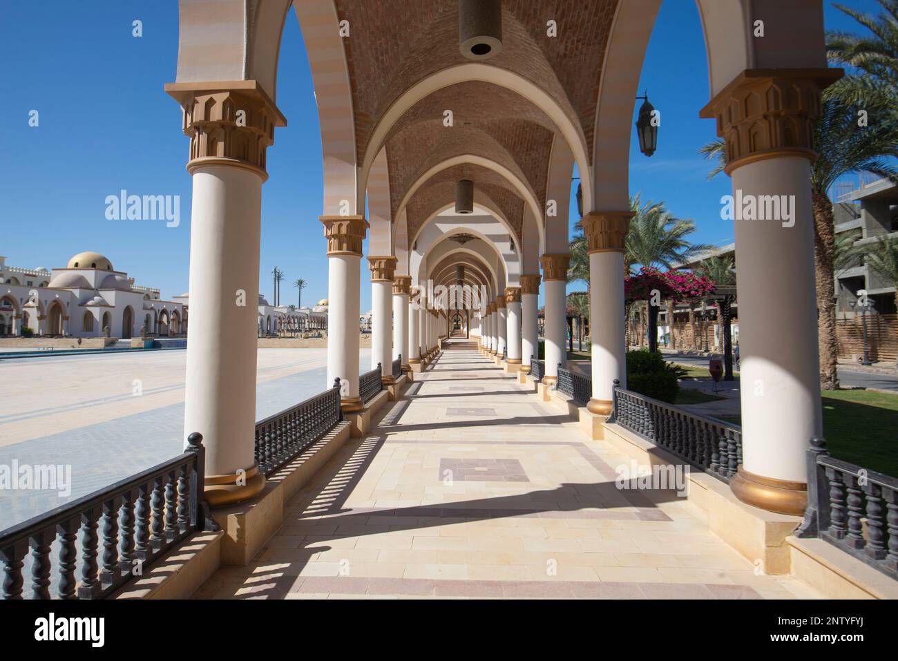 Corridor of arches diminishing to vanishing point at infinity abstract ...