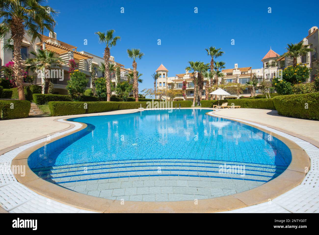 Large outdoor swimming pool at a luxury tropical hotel apartment resort ...