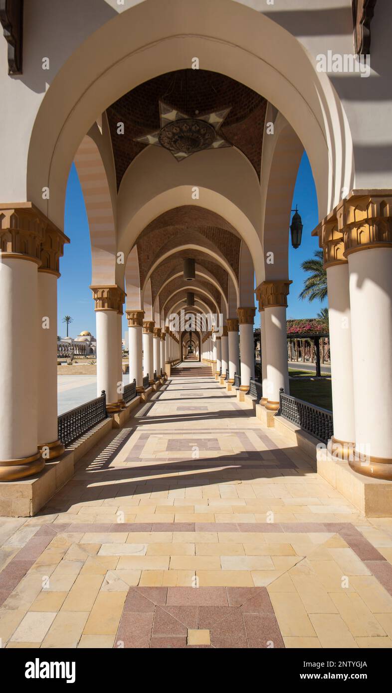 Corridor of arches diminishing to vanishing point at infinity abstract ...