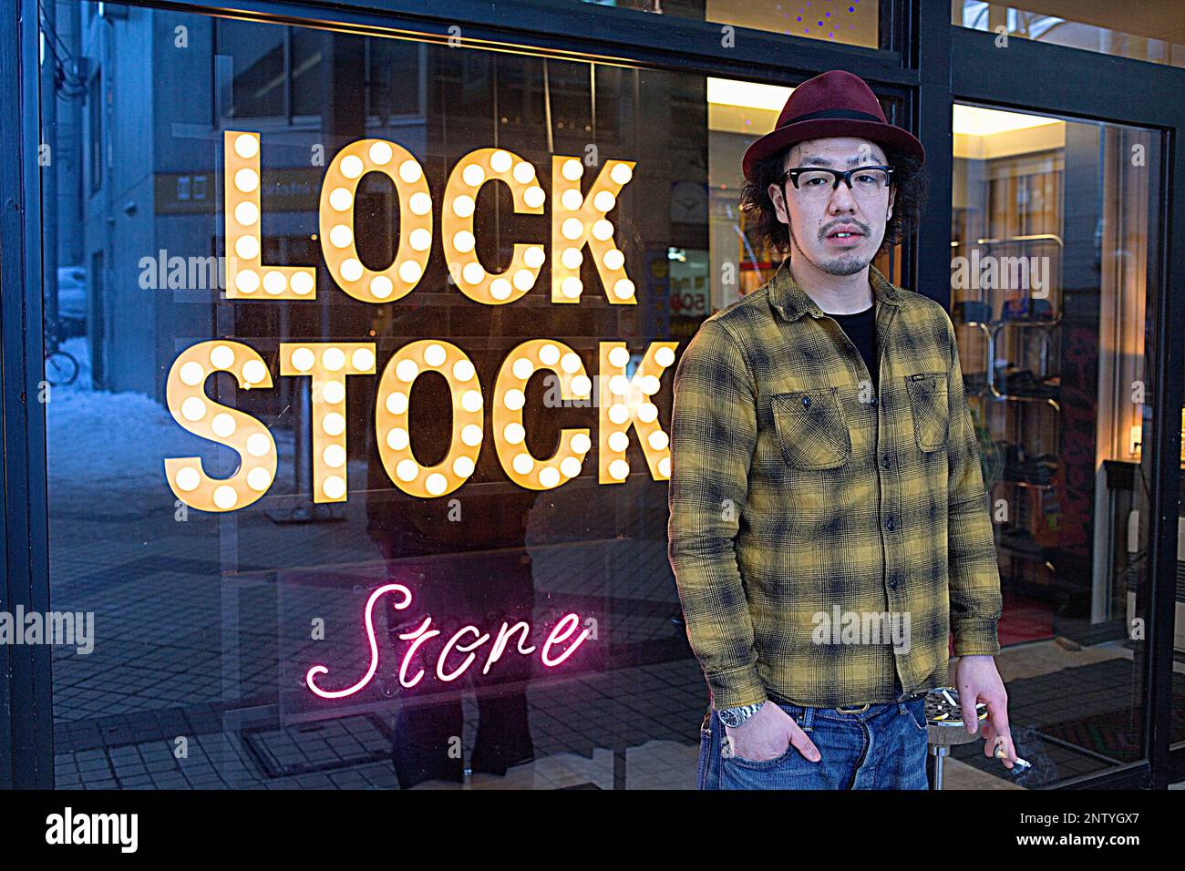 barber in front of his barbershop, in Tanukikoji shopping arcade ...