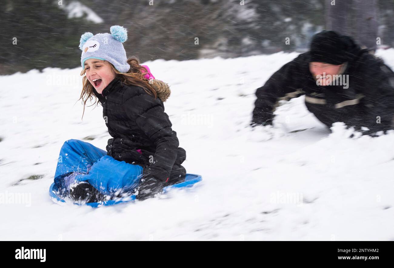Lucy McElligott gets a push from her father Patrick as she speeds down ...