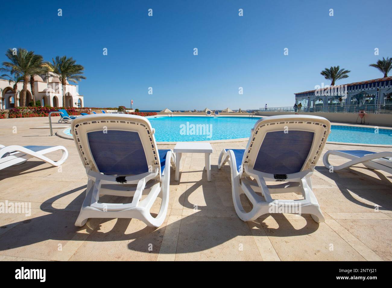 Large outdoor swimming pool with sun loungers at a luxury tropical ...