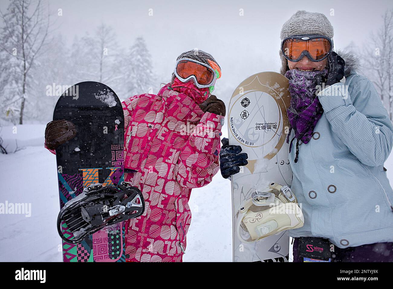 Two women with snowboards in Asahidake, Daisetsuzan National Park ...