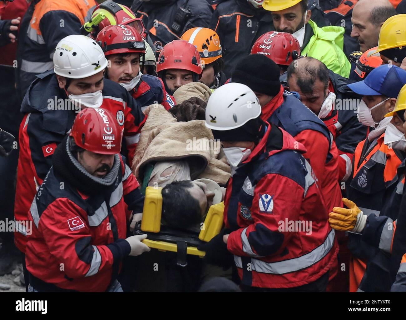 Turkish rescue workers carry a 16-year-old boy after they pulled him ...