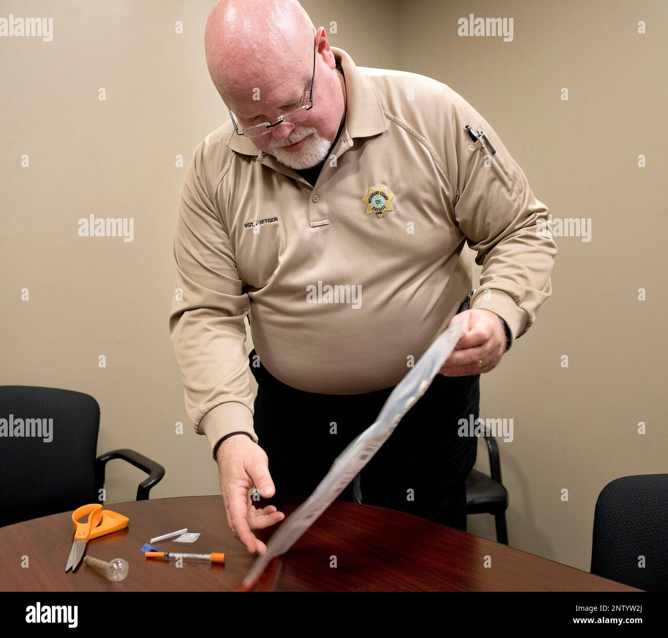 Sgt. Doug Boetger of the Woodbury County Sheriff's Office empties an ...