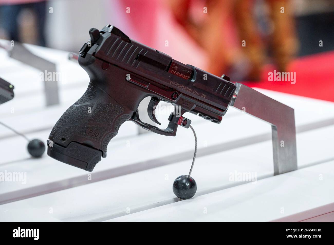 Nuremberg, Germany. 28th Feb, 2023. A P30 pistol is on display at the Heckler & Koch booth. The ...