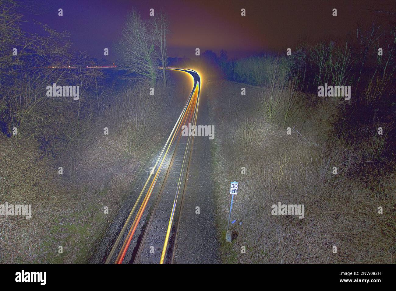 Long-term HDR shot at night of train tracks where a train has passed ...