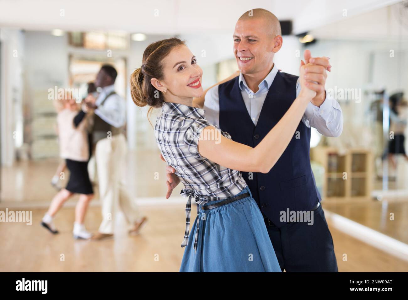 Man and woman performing ballroom dance in dancing room Stock Photo - Alamy