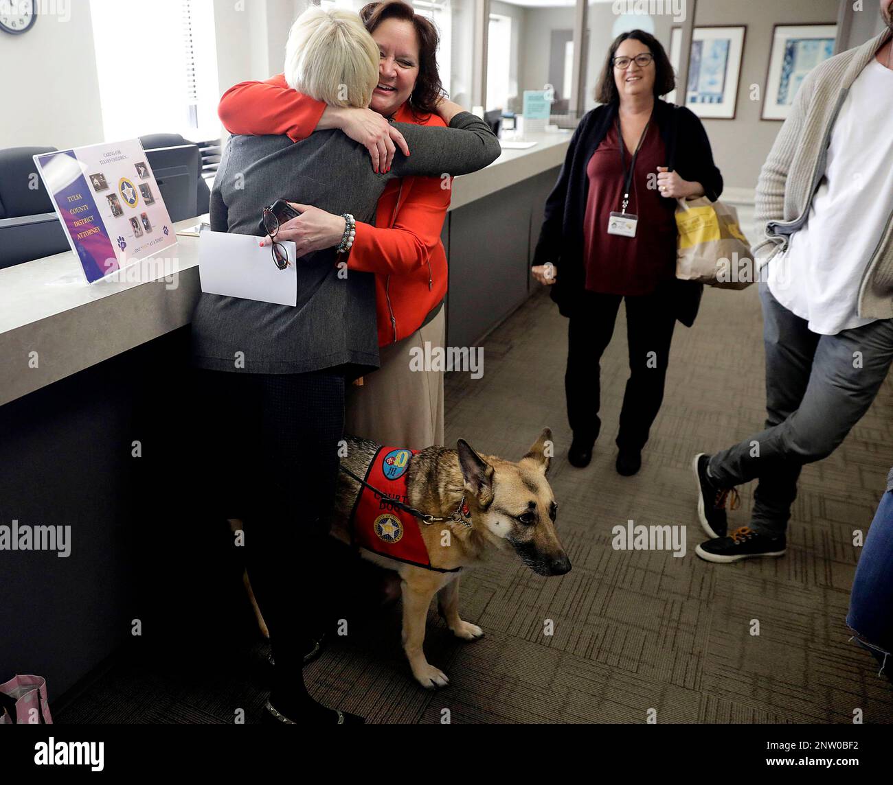 Debra Cox, left, receives a hug from Sally Van Schenck, who directs the ...